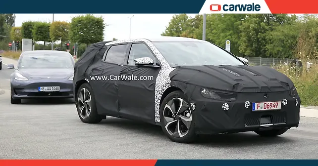 Kia electric crossover spied alongside the Tesla Model 3 - CarWale